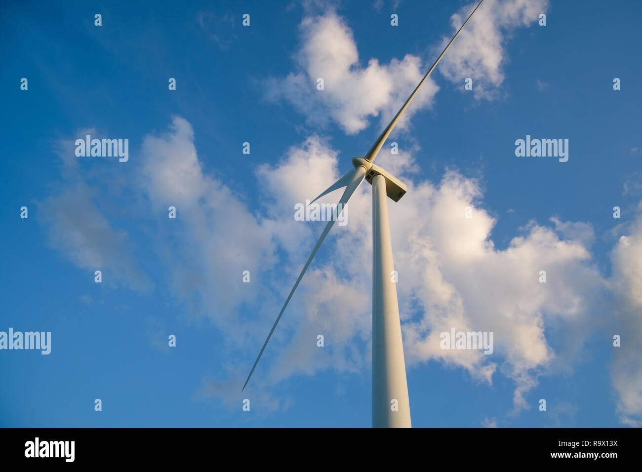 View up, bottom view of wind turbine, windmill isolated on blue sky ...