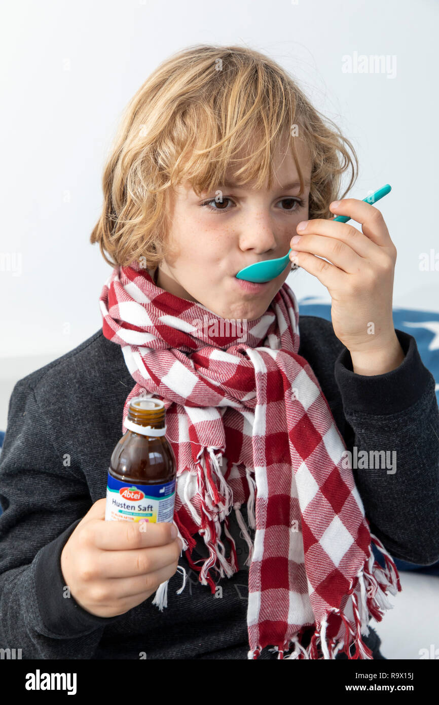 A little boy takes medicine, he has a cold, cough syrup Stock Photo - Alamy