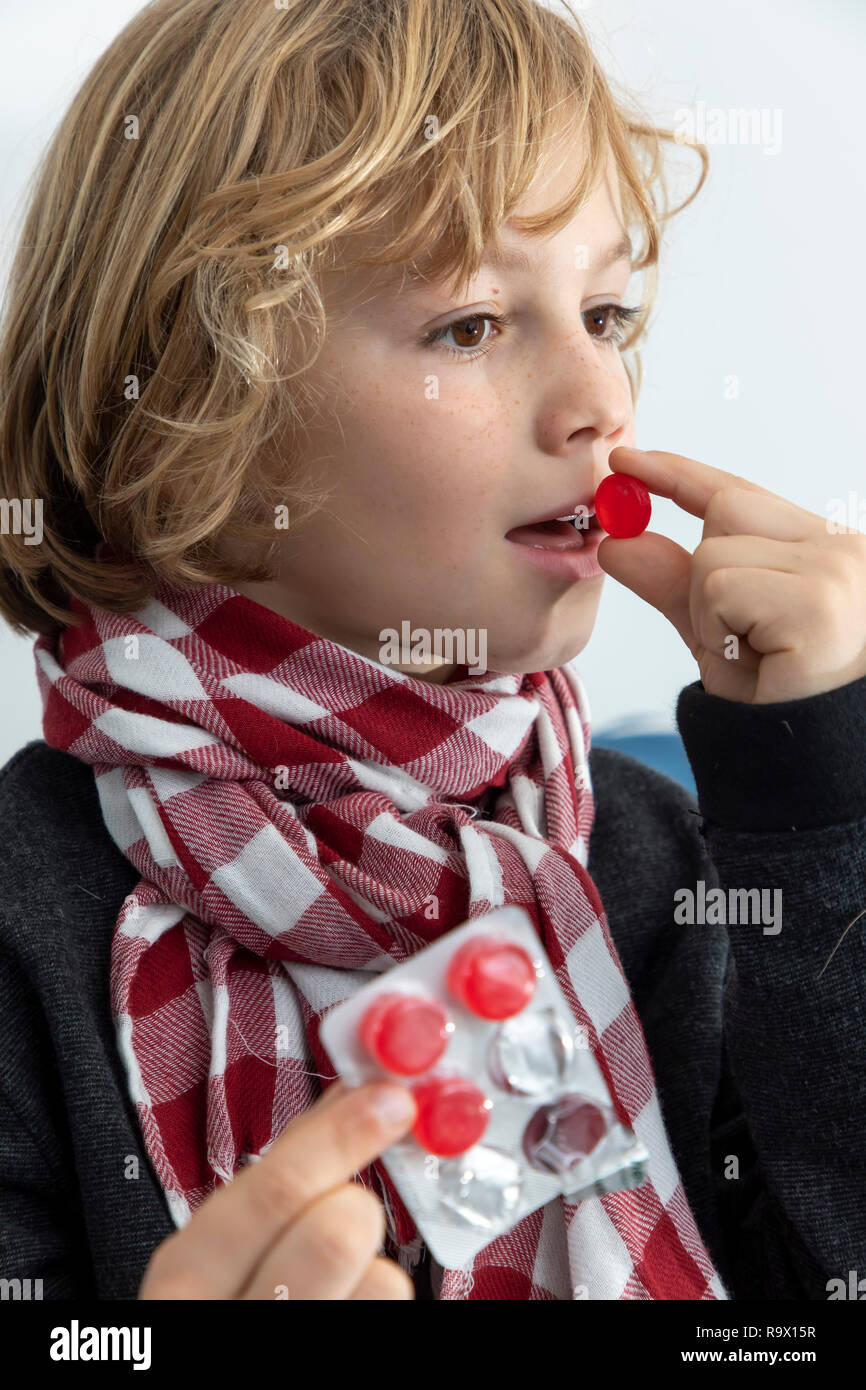A little boy takes medicine, he has a cold, lozenge for cough Stock ...