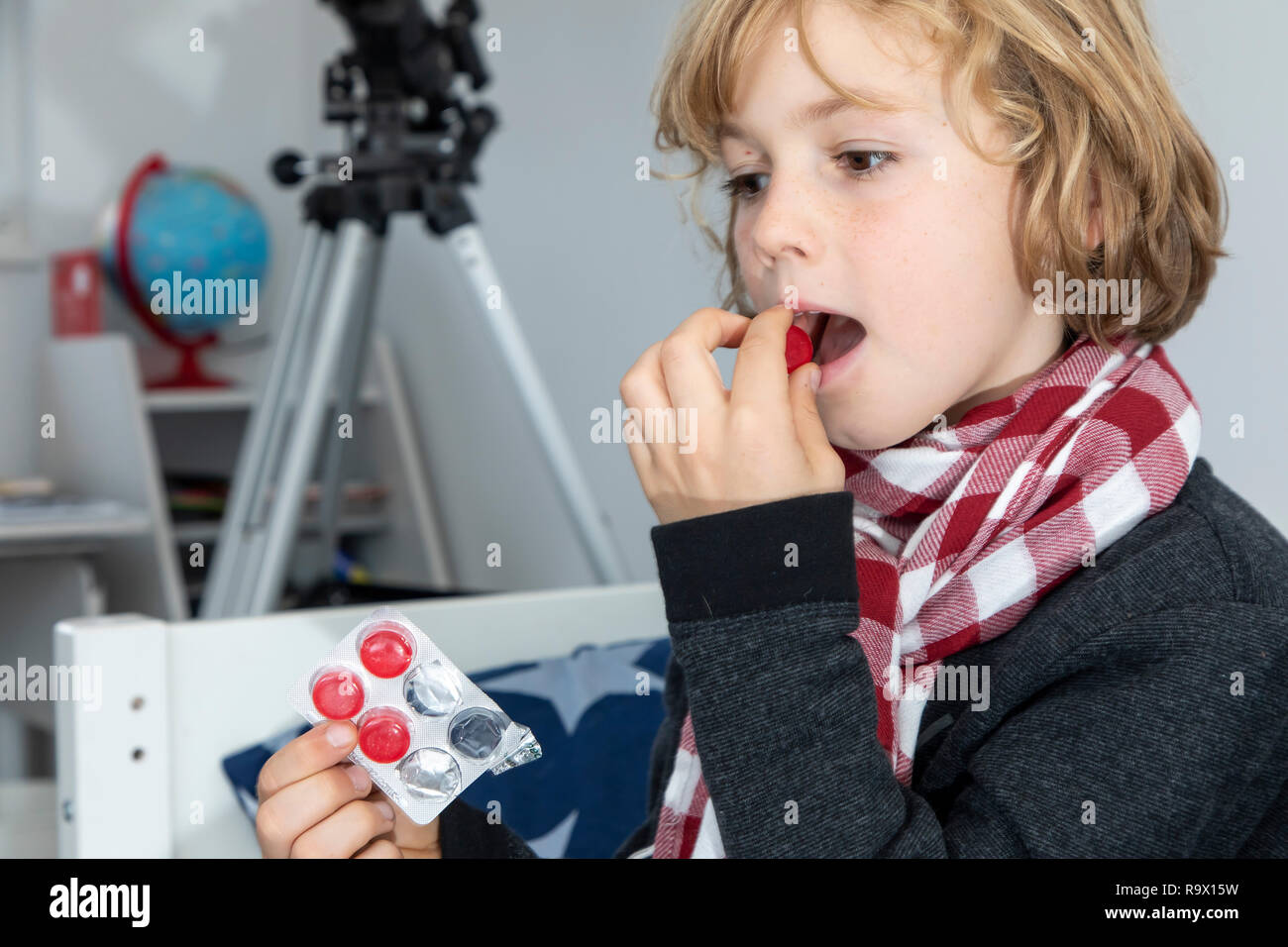 A little boy takes medicine, he has a cold, lozenge for cough Stock ...