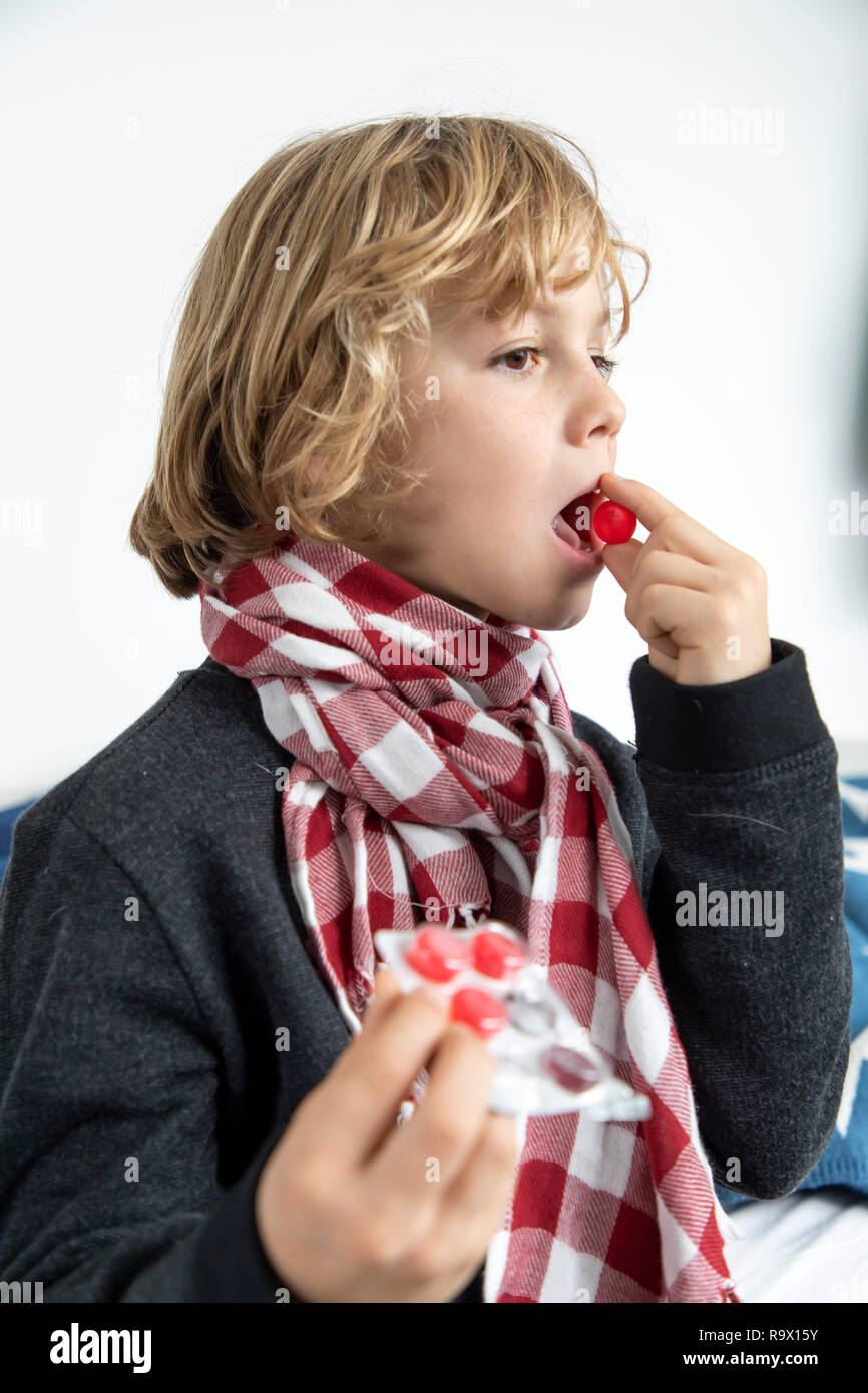 A little boy takes medicine, he has a cold, lozenge for cough Stock ...