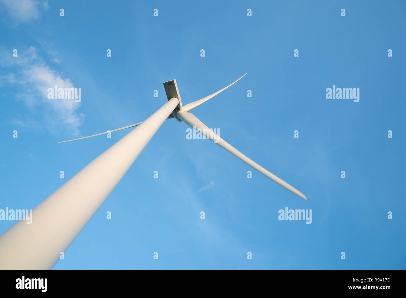 View up, bottom view of wind turbine, windmill isolated on blue sky ...