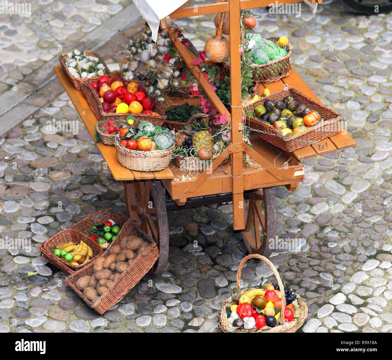 medieval cart of greengrocer with fruit and vegetables for sale on the ...