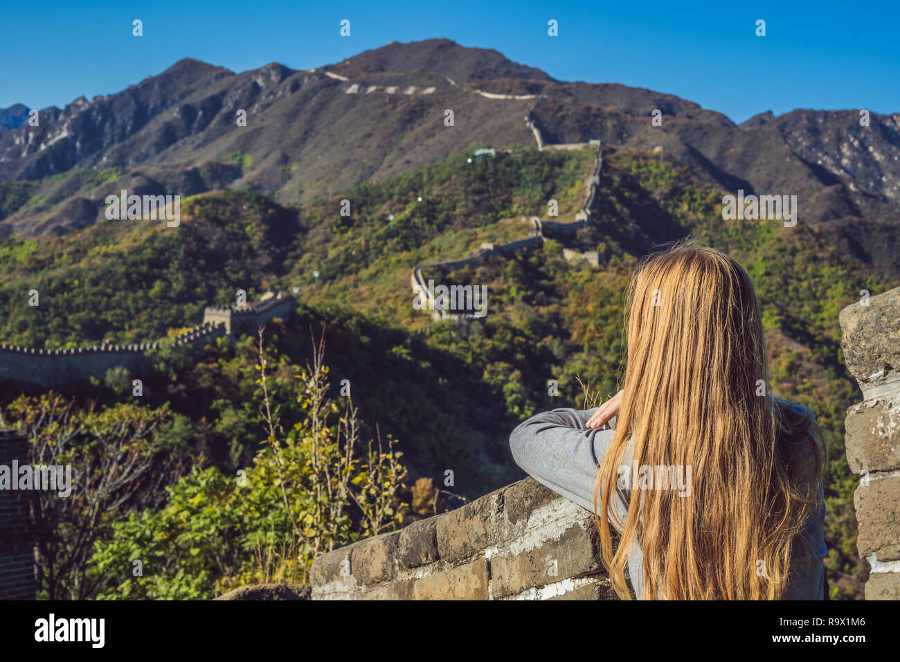 Happy cheerful joyful tourist woman at Great Wall of China having fun ...
