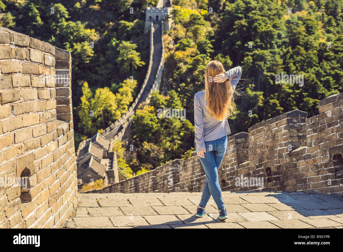 Happy cheerful joyful tourist woman at Great Wall of China having fun ...