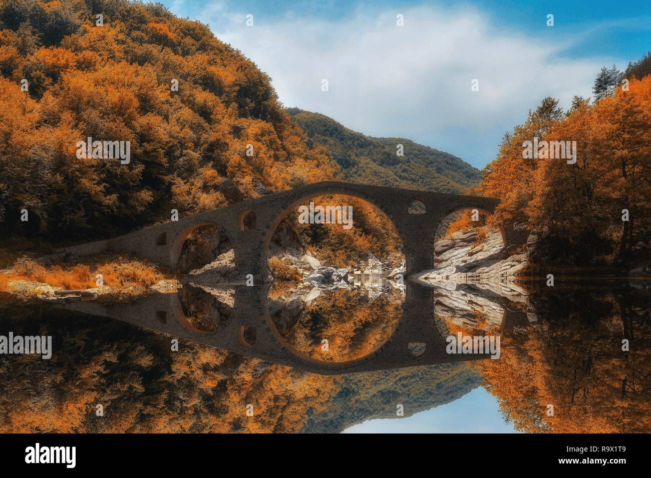 Devil's bridge, Bulgaria. Ancient stone bridge over Arda river, autumn ...
