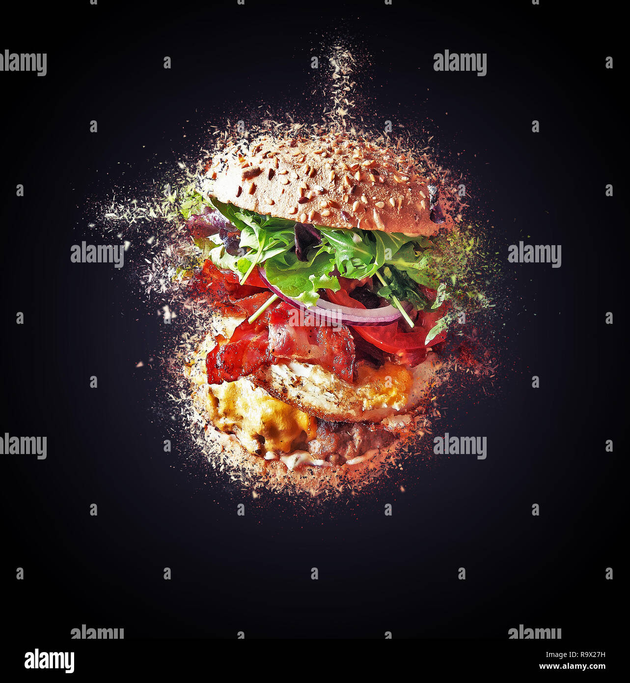 Big burger flying and exploding against Black background Stock Photo ...