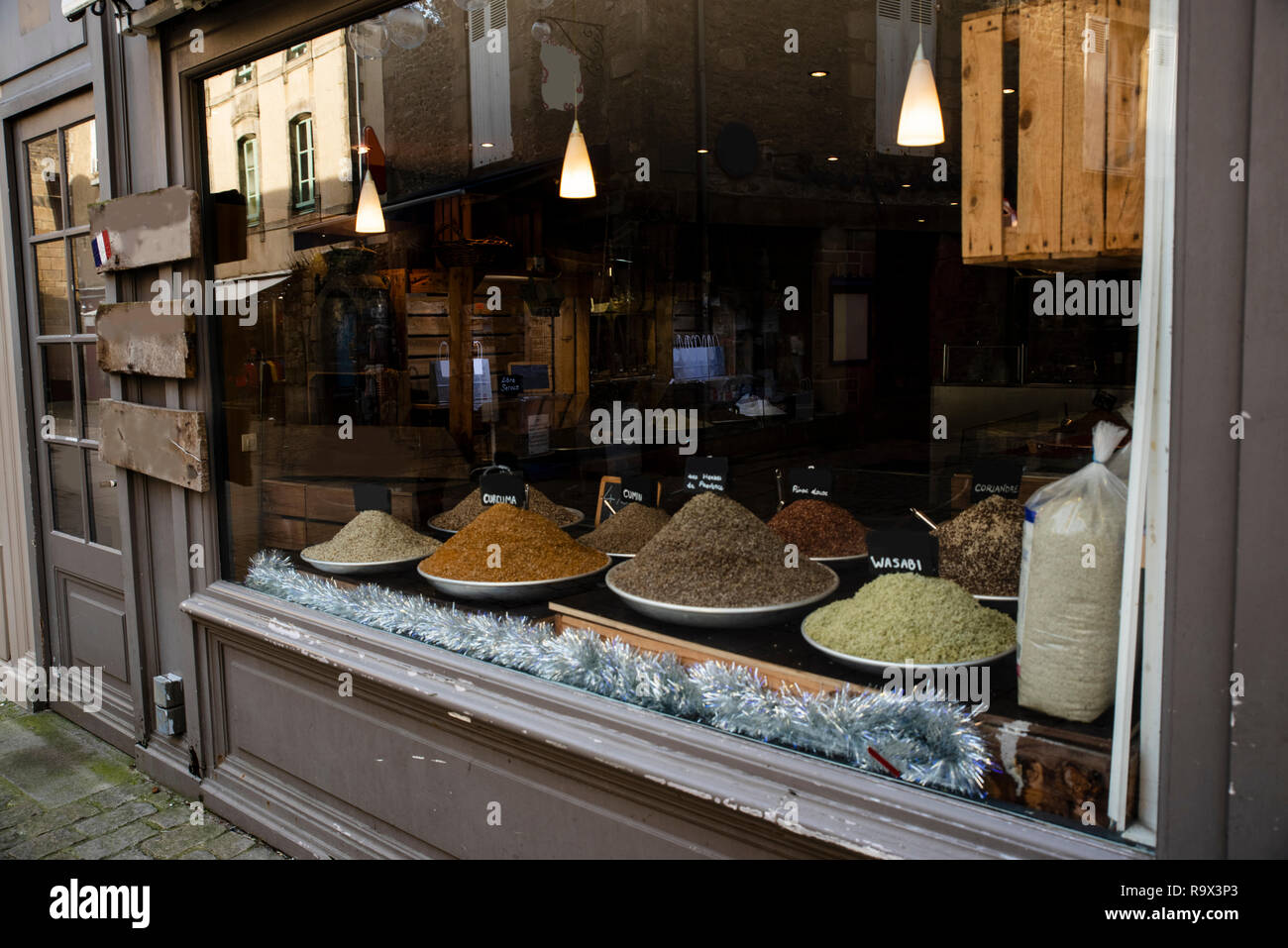 Shop window with salt flavoured with different spices. Reflection in ...