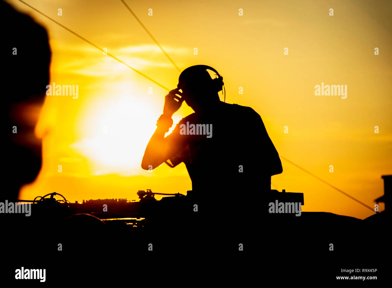 silhouette of DJ against sunset sky ar rooftop gig Marseille South of ...