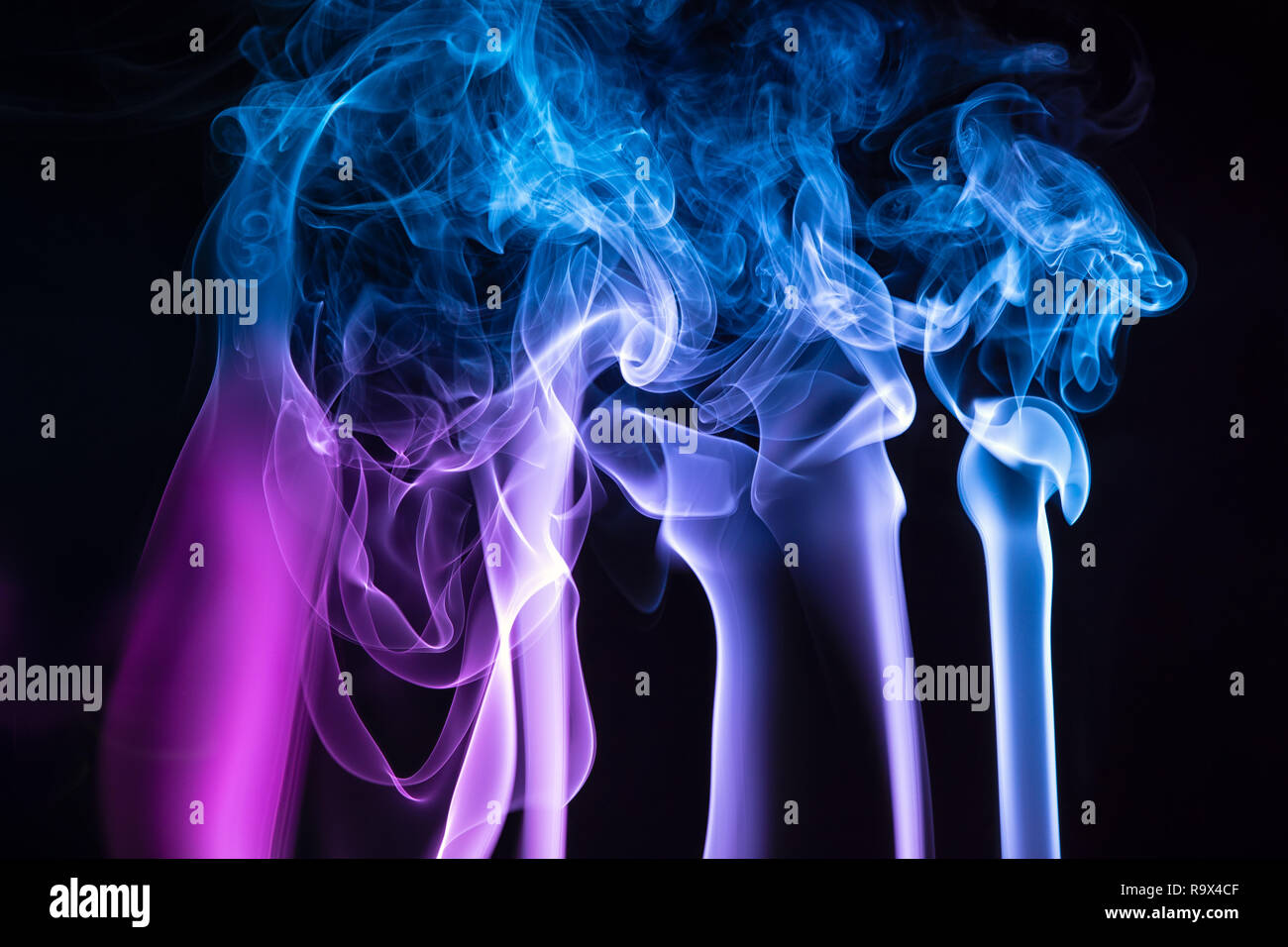 Colorful smoke of incence stick isolated at black background Stock ...
