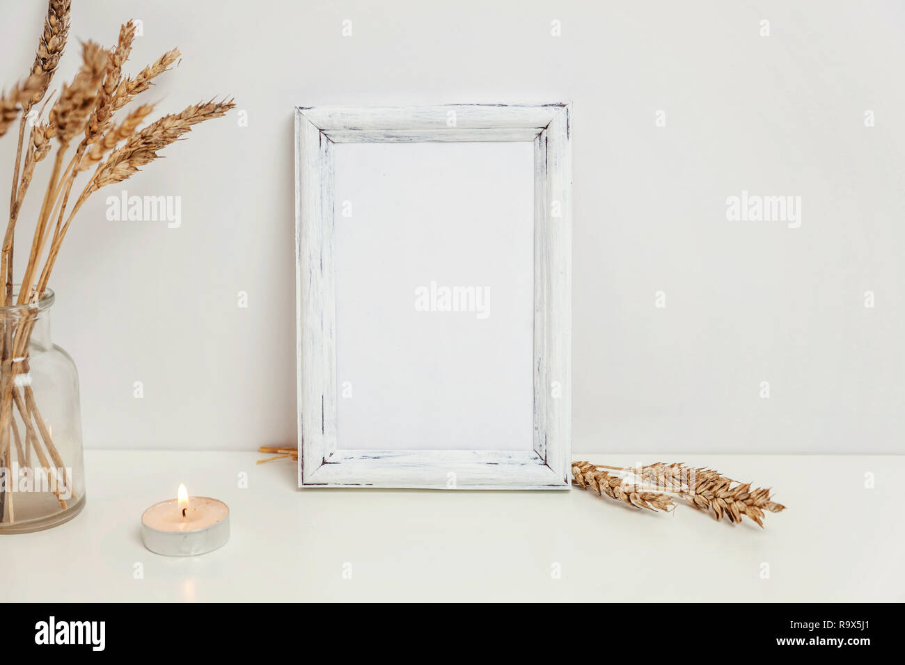 Vertical frame mockup with wild rye bouquet in glass vase near white ...