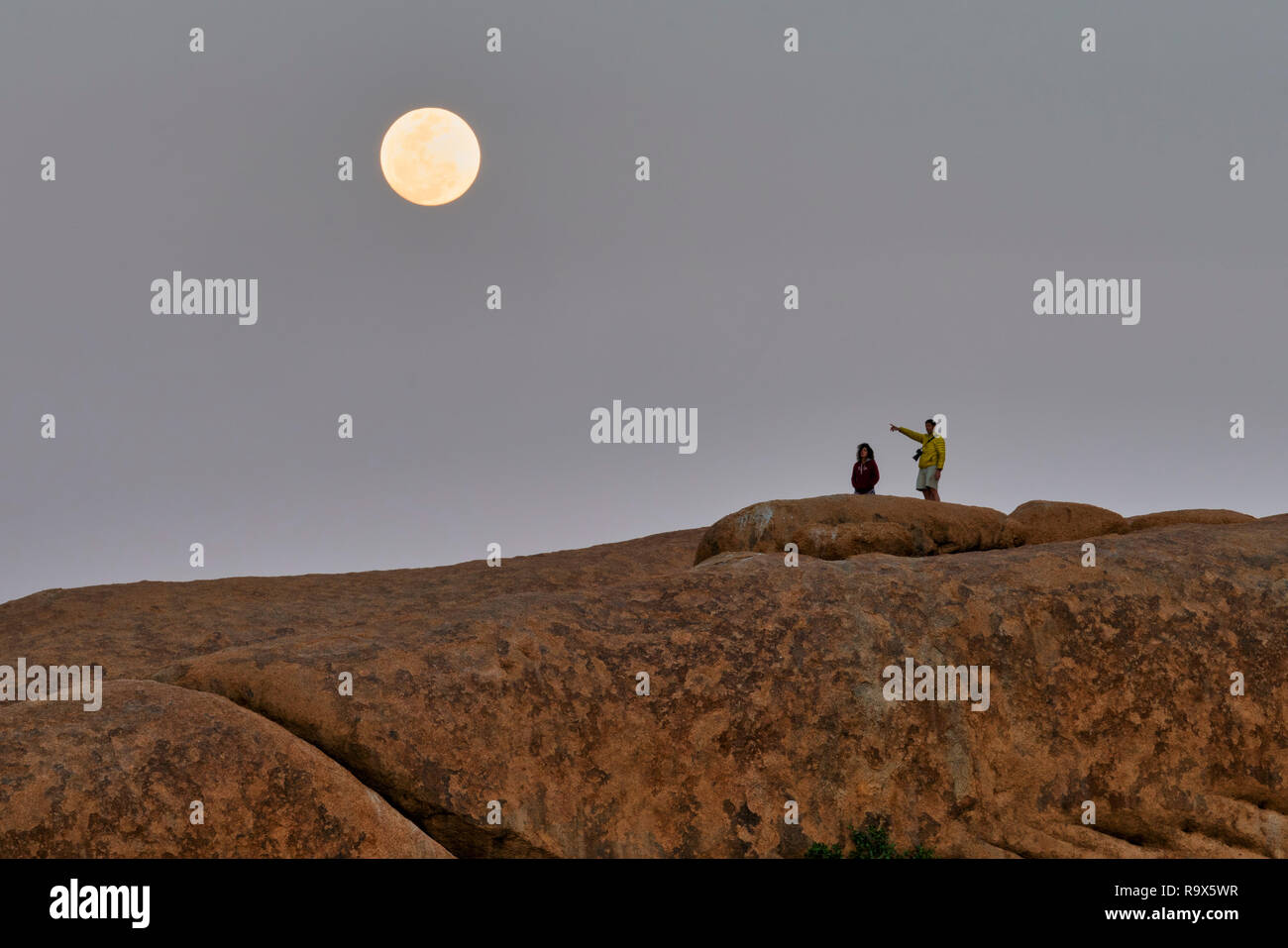 Pointing to full moon Stock Photo - Alamy