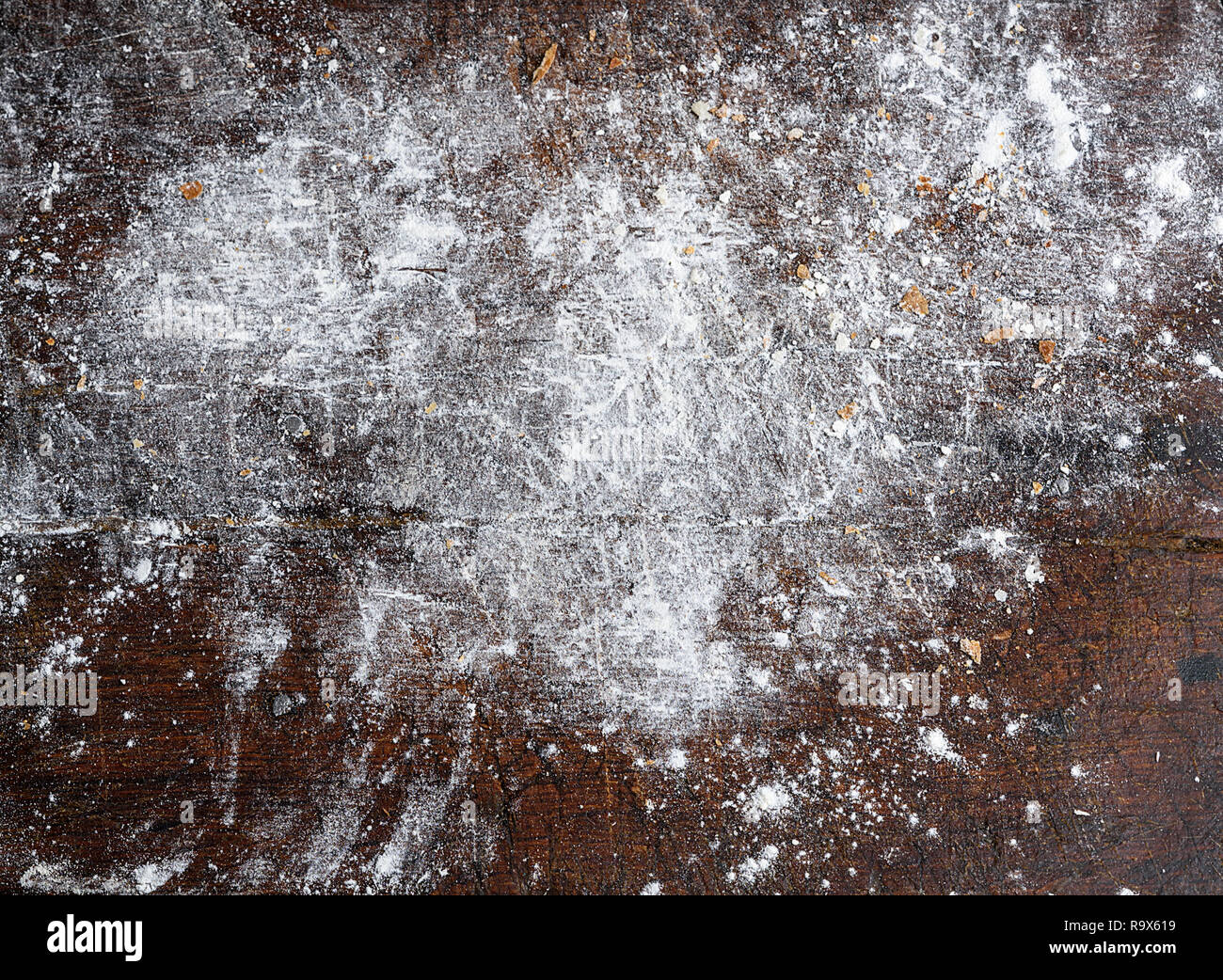the old brown board is sprinkled with white wheat flour, full frame ...