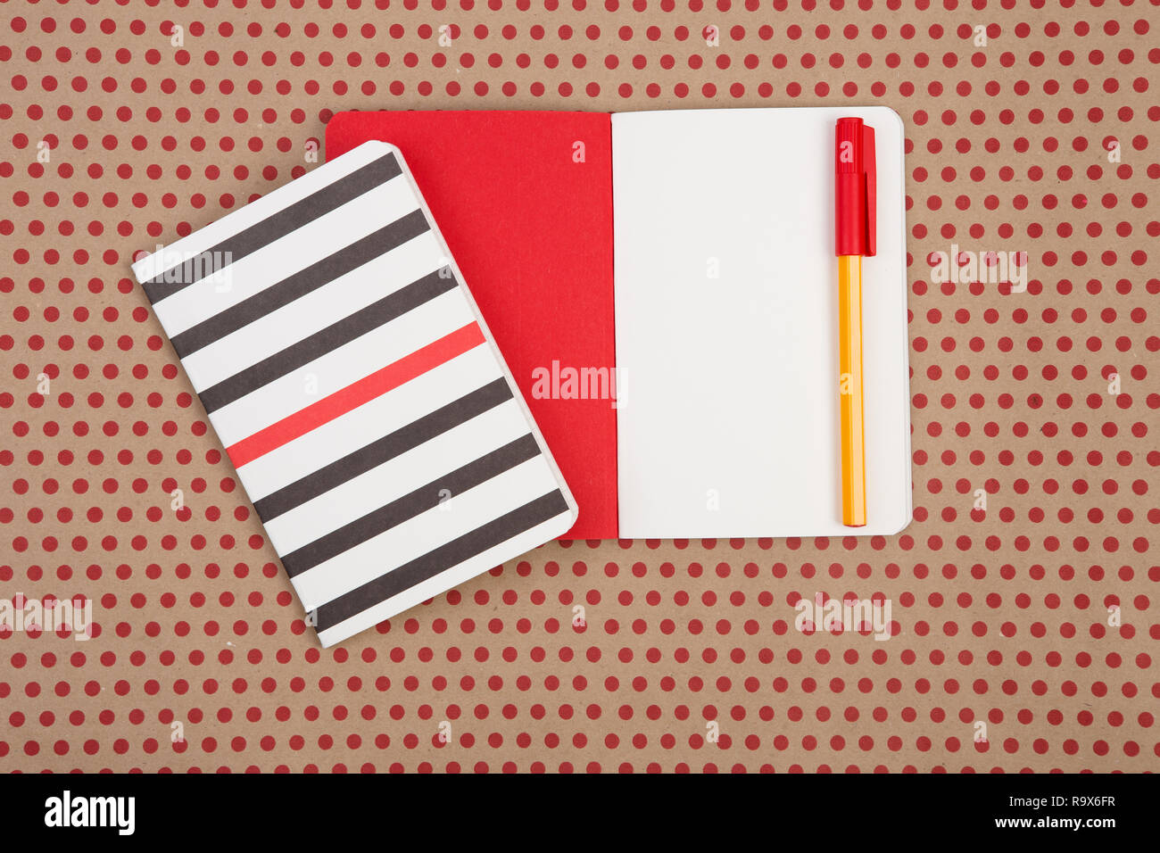 Education Concept and desk accessories - red and striped notepads with ...