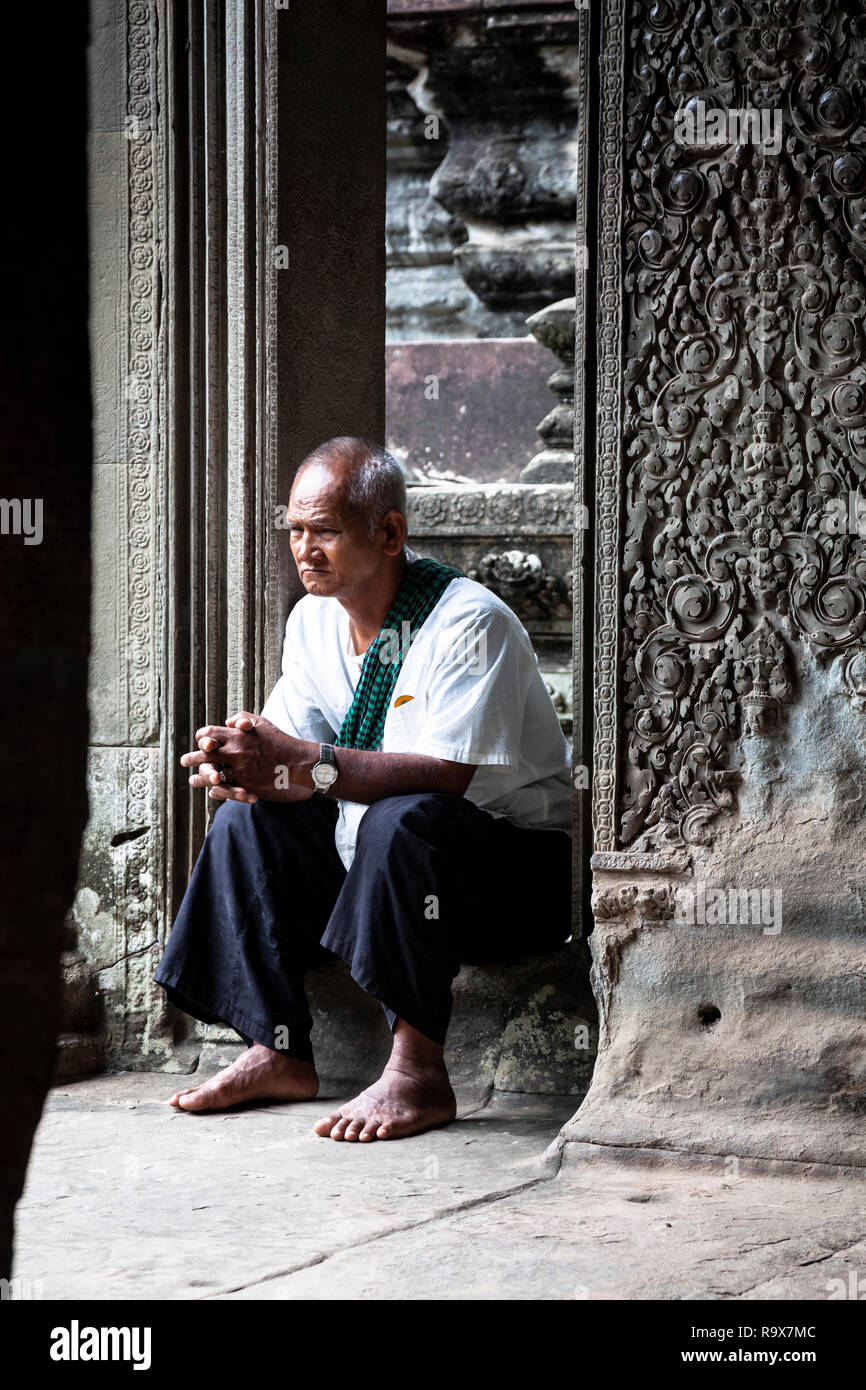 Old man sitting in a stone temple Stock Photo - Alamy