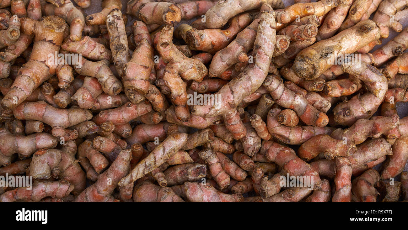 Curcuma turmeric roots background pattern Stock Photo - Alamy