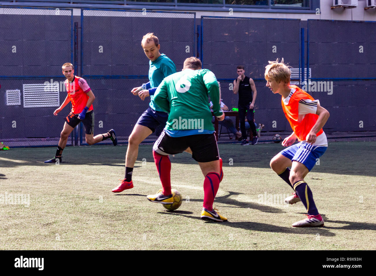 Young people play football on the green grass Stock Photo - Alamy
