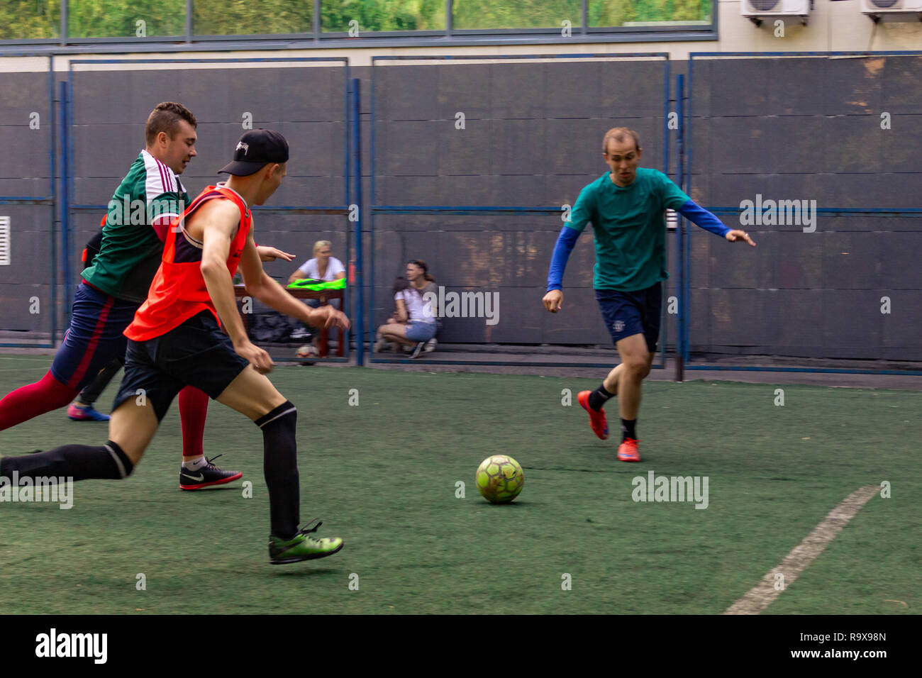 Young people play football on the green grass Stock Photo - Alamy