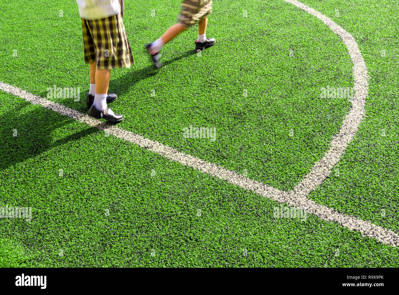 Children play on the artificial turf of the school Stock Photo - Alamy
