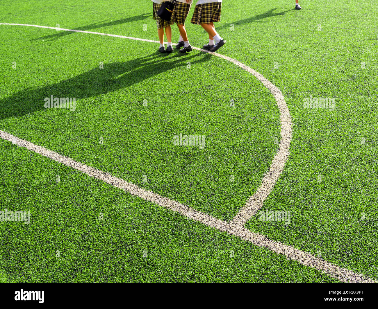 Children play on the artificial turf of the school Stock Photo - Alamy