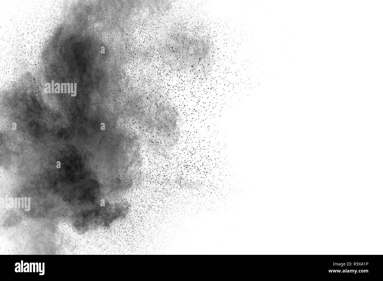 Black particles splattered on white background. Black powder dust ...