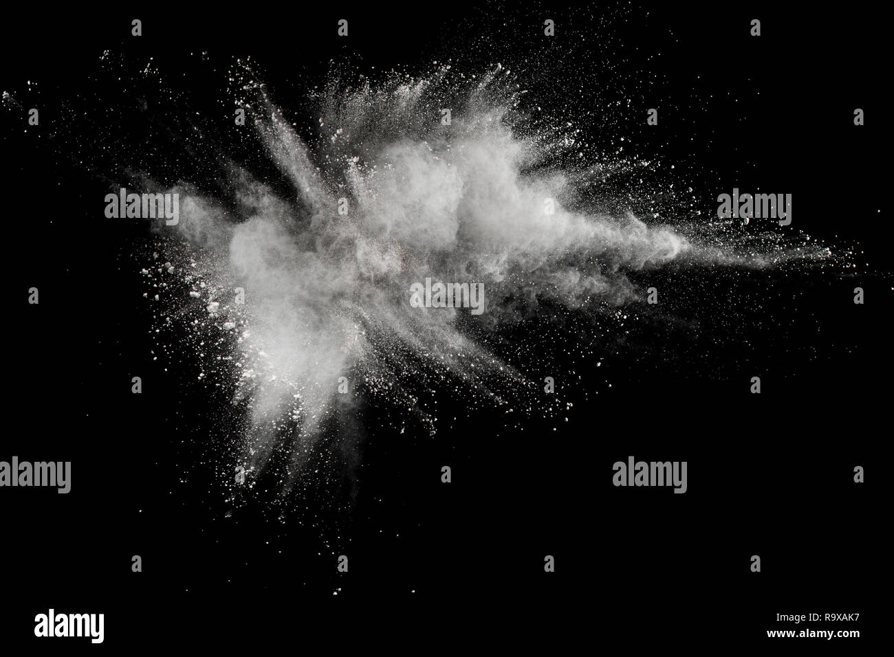 Bizarre forms of white powder explosion on white background.Launched ...
