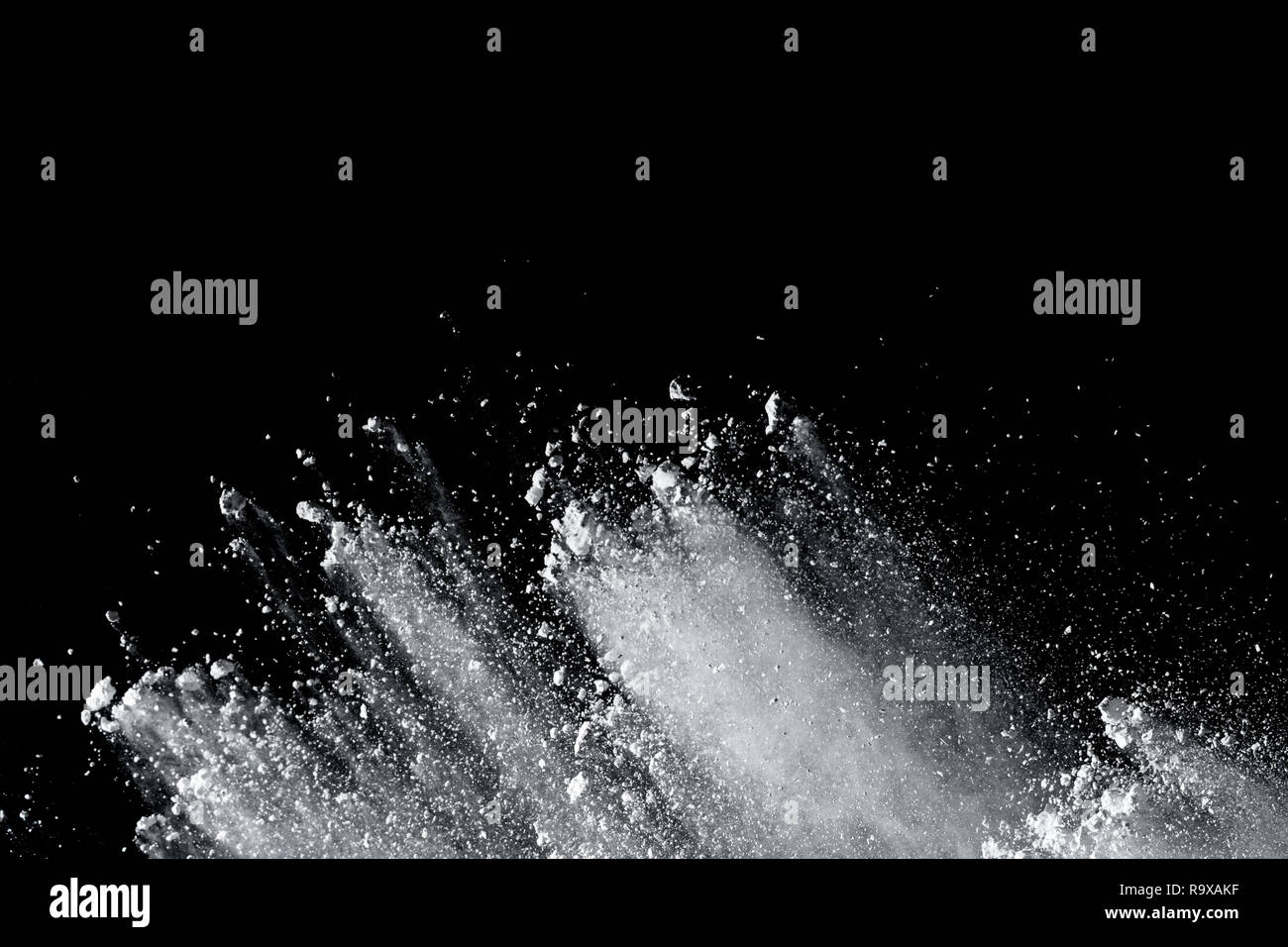 Bizarre forms of white powder explosion cloud against dark background ...