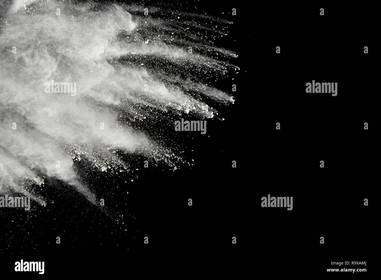 Bizarre forms of white powder explosion on white background.Launched ...