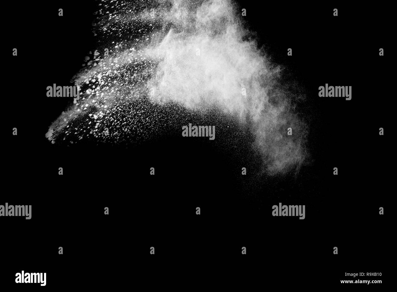 Bizarre forms of white powder explosion on white background.Launched ...