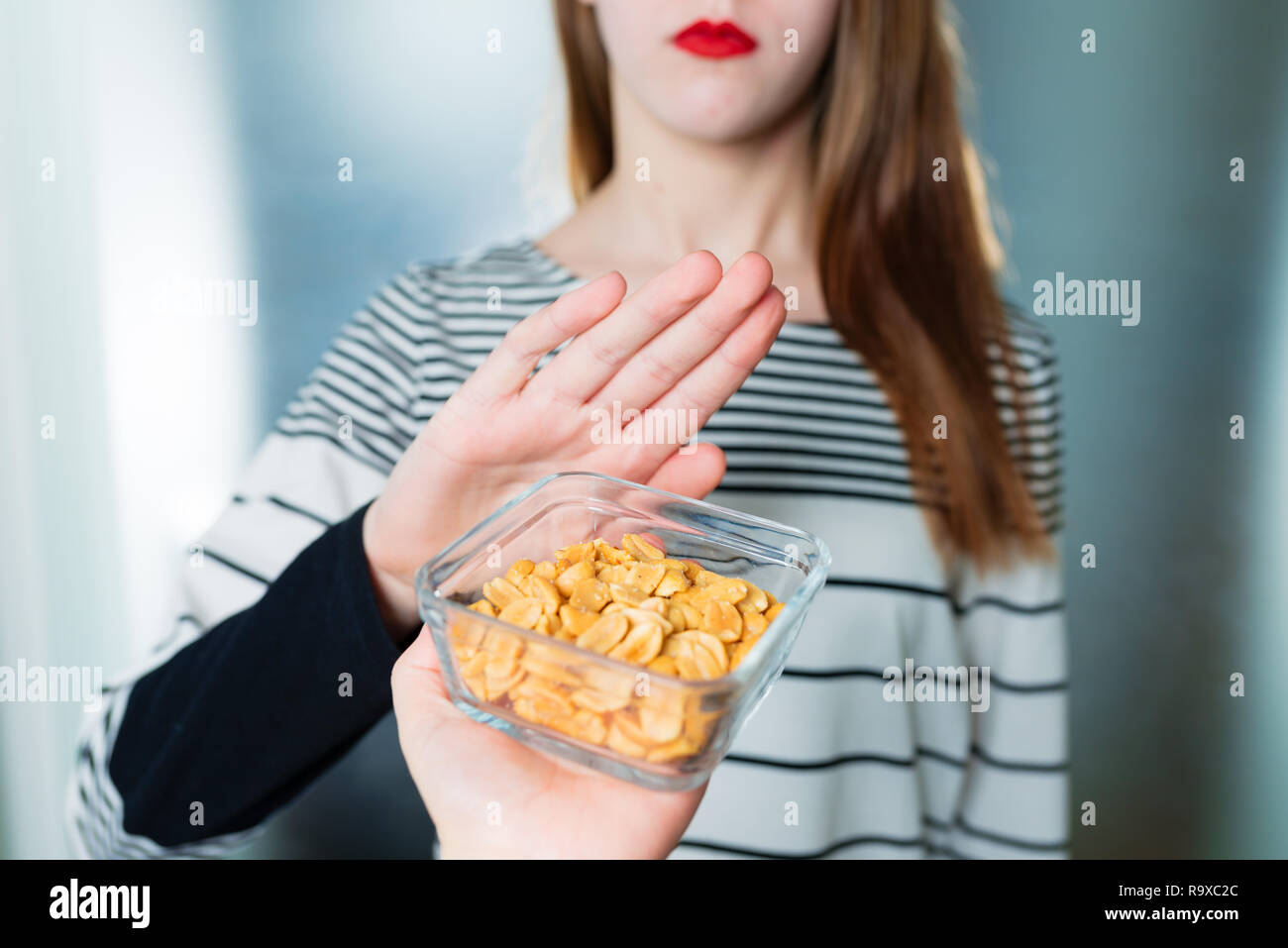 Peanut allergy concept - food intolerance. Young girl refuses to eat ...