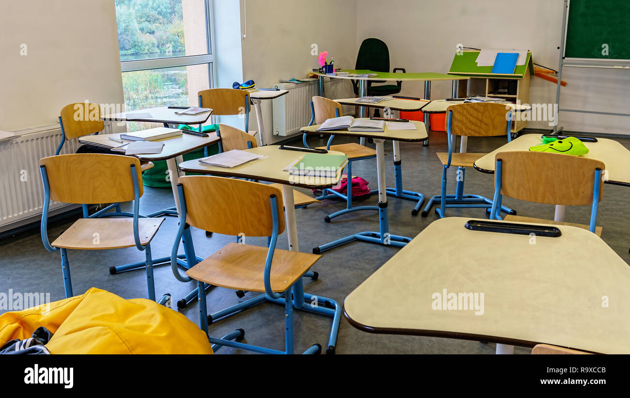 Interior of classroom in the modern school. School board, desks ...