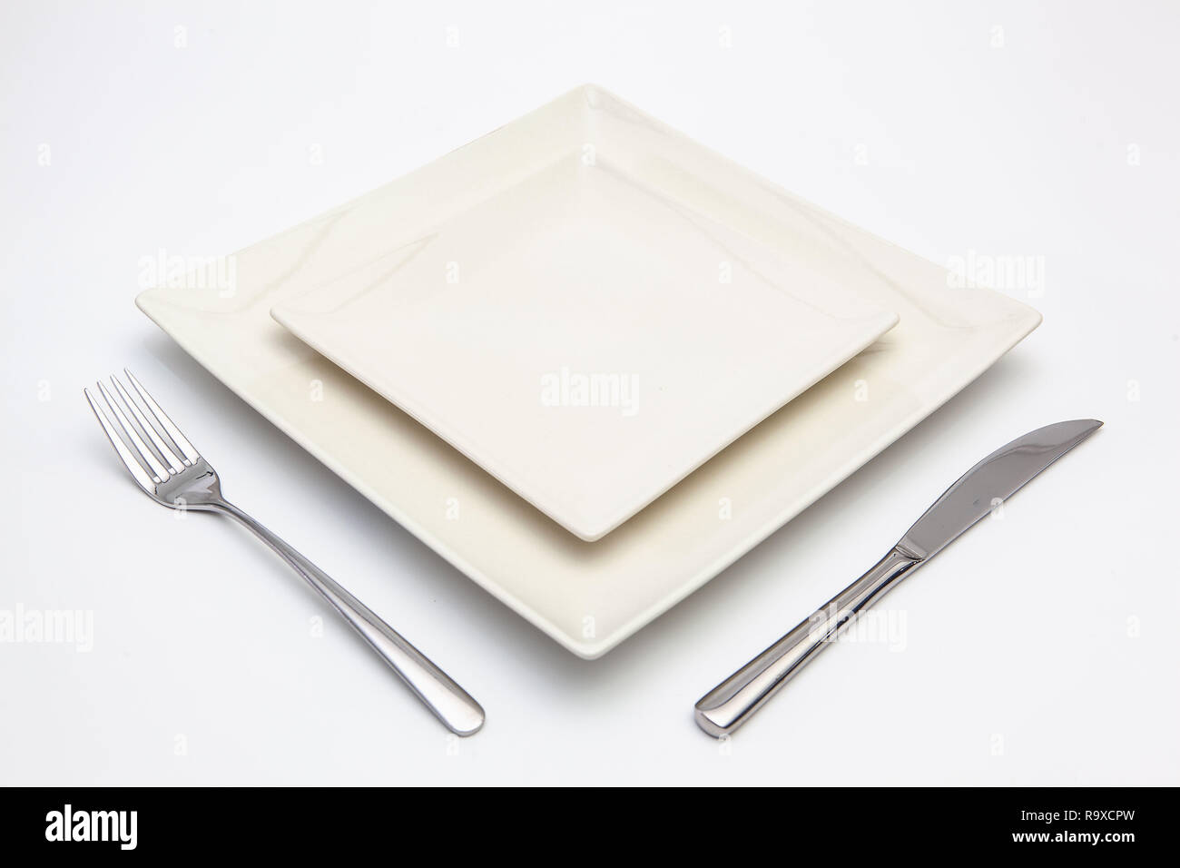 White square plate on the white wooden table.Top view.Flat Lay Image ...