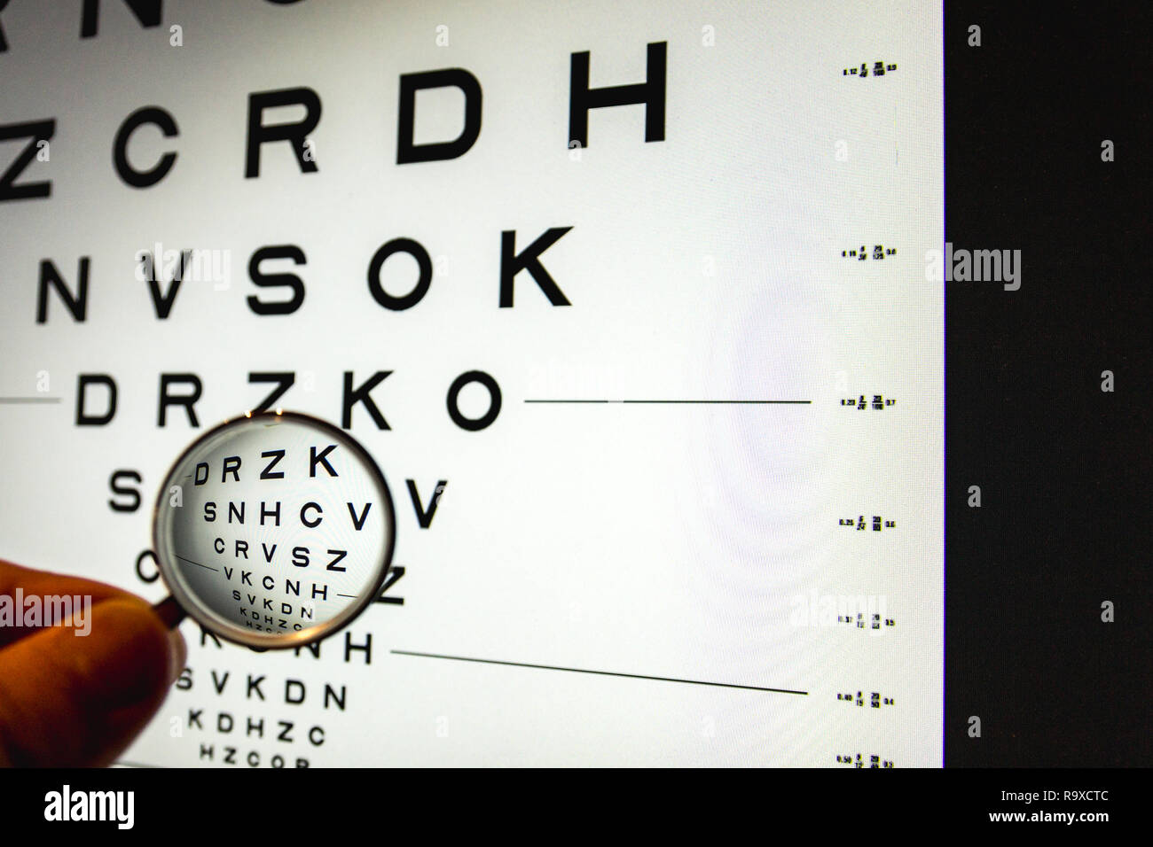 negative concave ophthalmic lens on a blurred background of the ETDRS ...