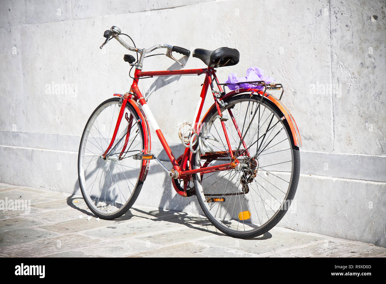 Red bicycle against a marble wall (Tuscany - Italy Stock Photo - Alamy