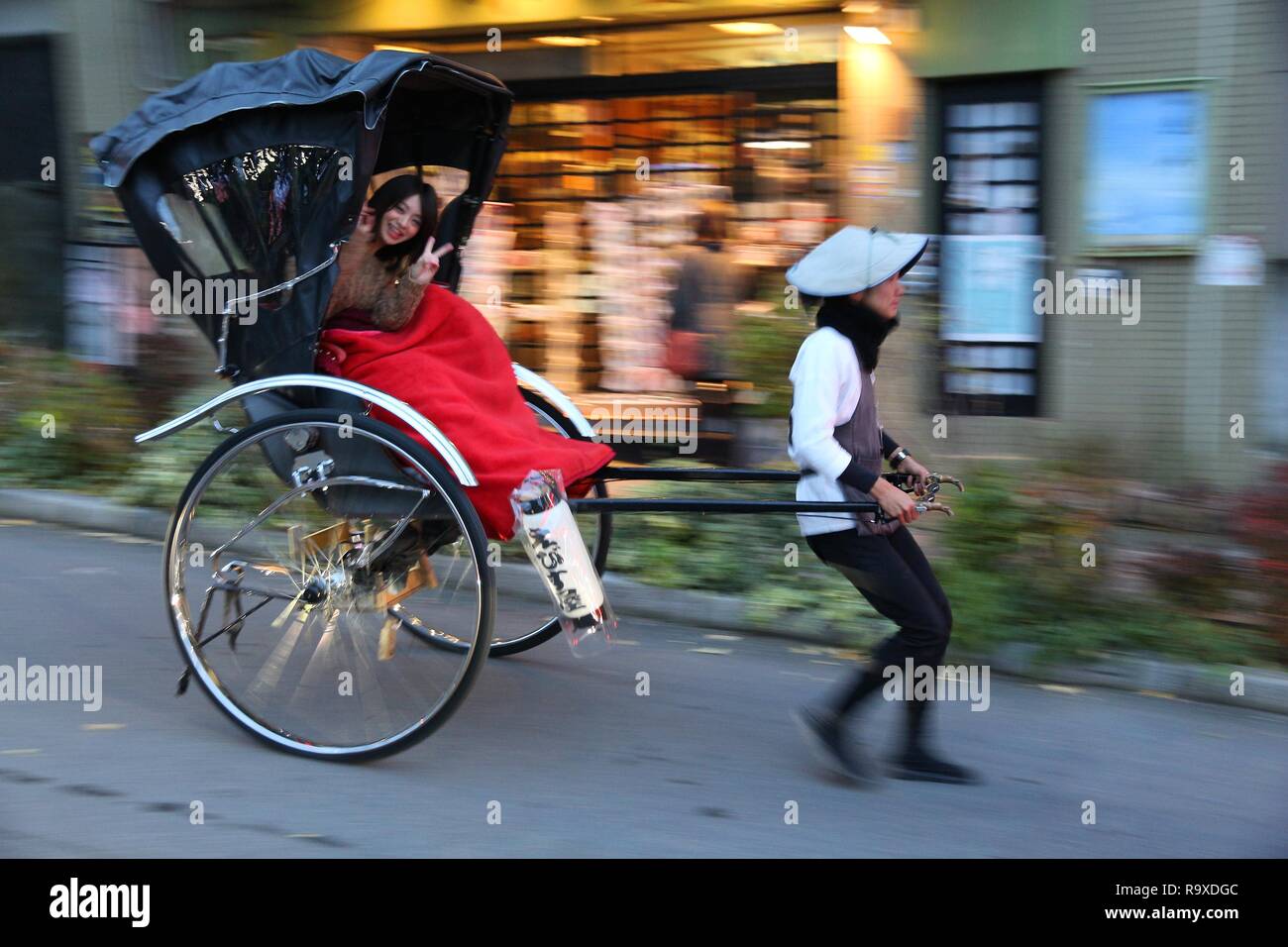 KYOTO, JAPAN - NOVEMBER 27, 2016: Women ride a rickshaw in Kyoto, Japan ...