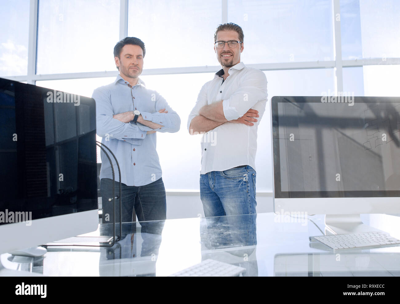two employees standing in a modern office Stock Photo - Alamy