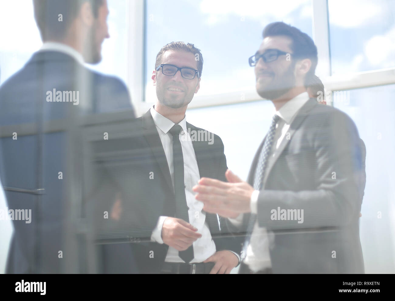 group of business people talking in the office hall Stock Photo - Alamy