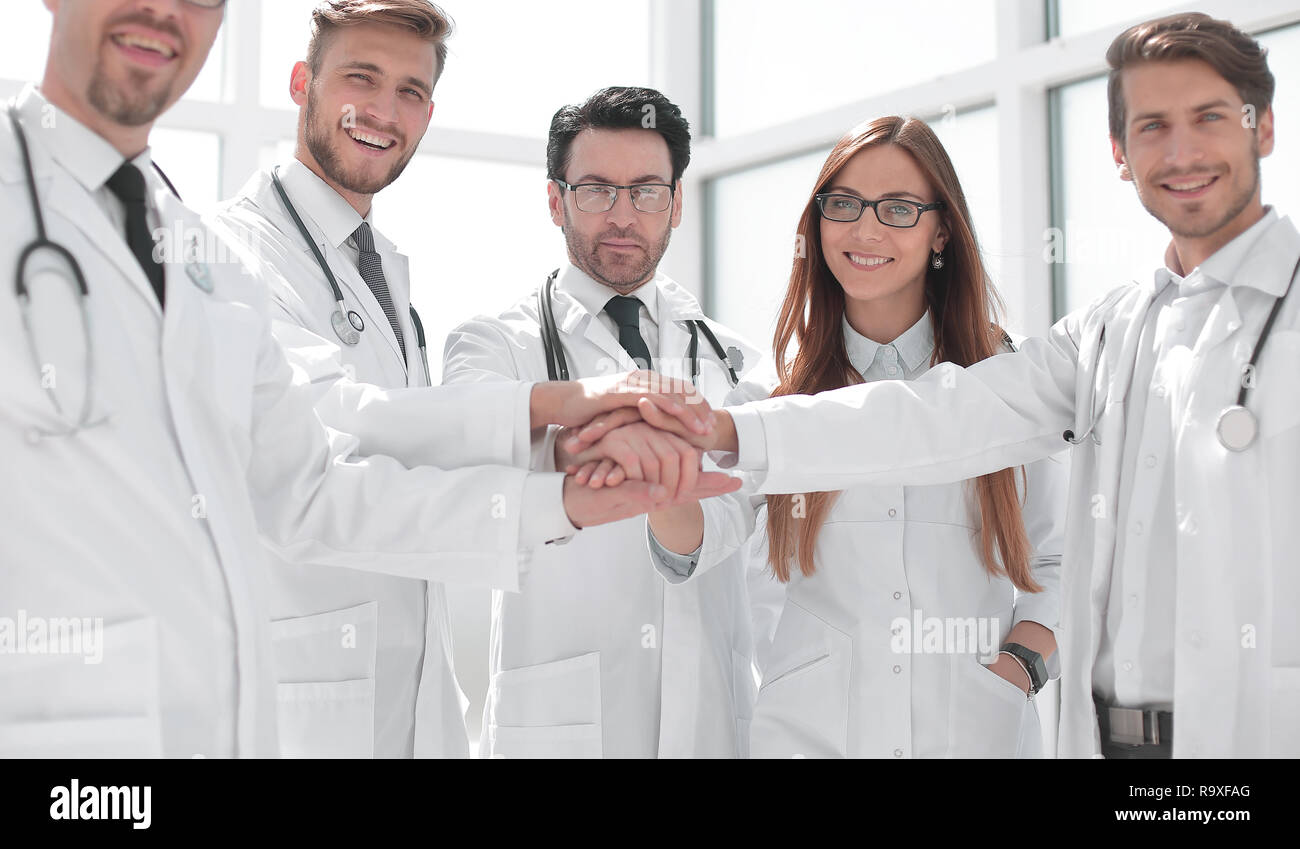 group of doctors with their hands folded together Stock Photo - Alamy