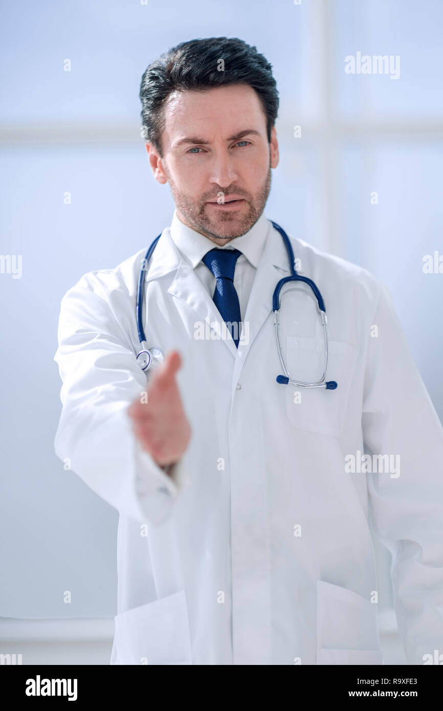 background image of the doctor holding out his hand for greeting Stock ...