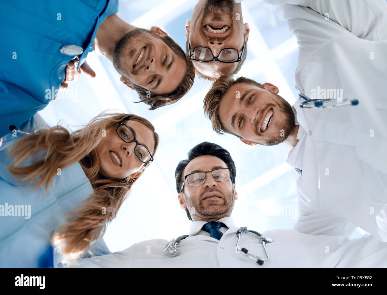 doctors looking down smiling at the camera Stock Photo - Alamy