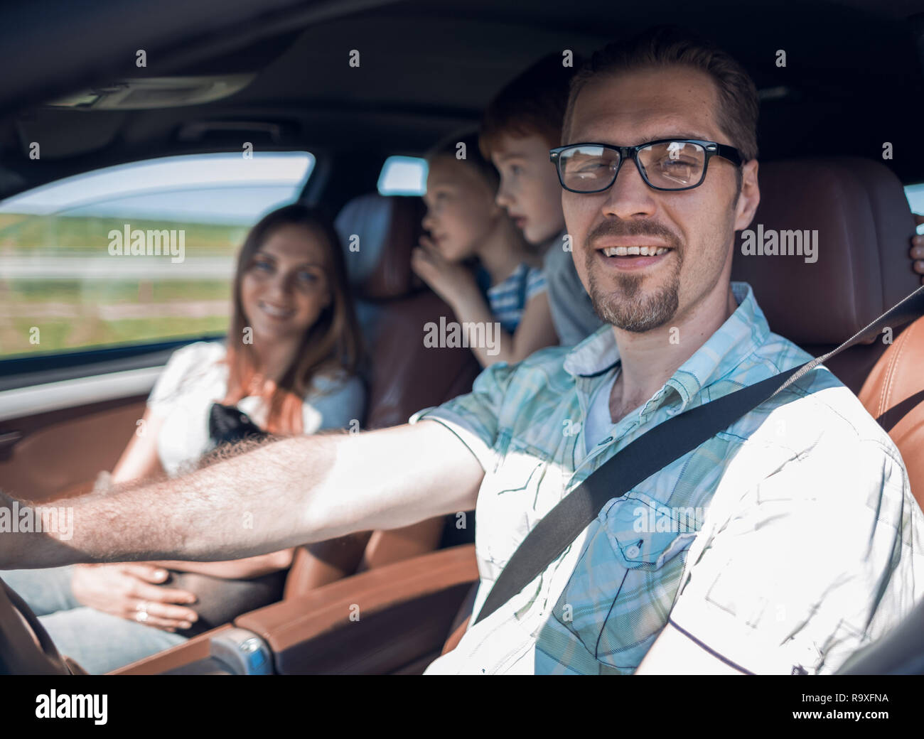 side view.happy father driving a car Stock Photo - Alamy