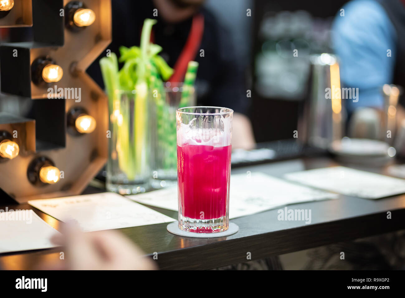 Refreshing cold pink cocktail in a tall glass on bar counter Stock ...
