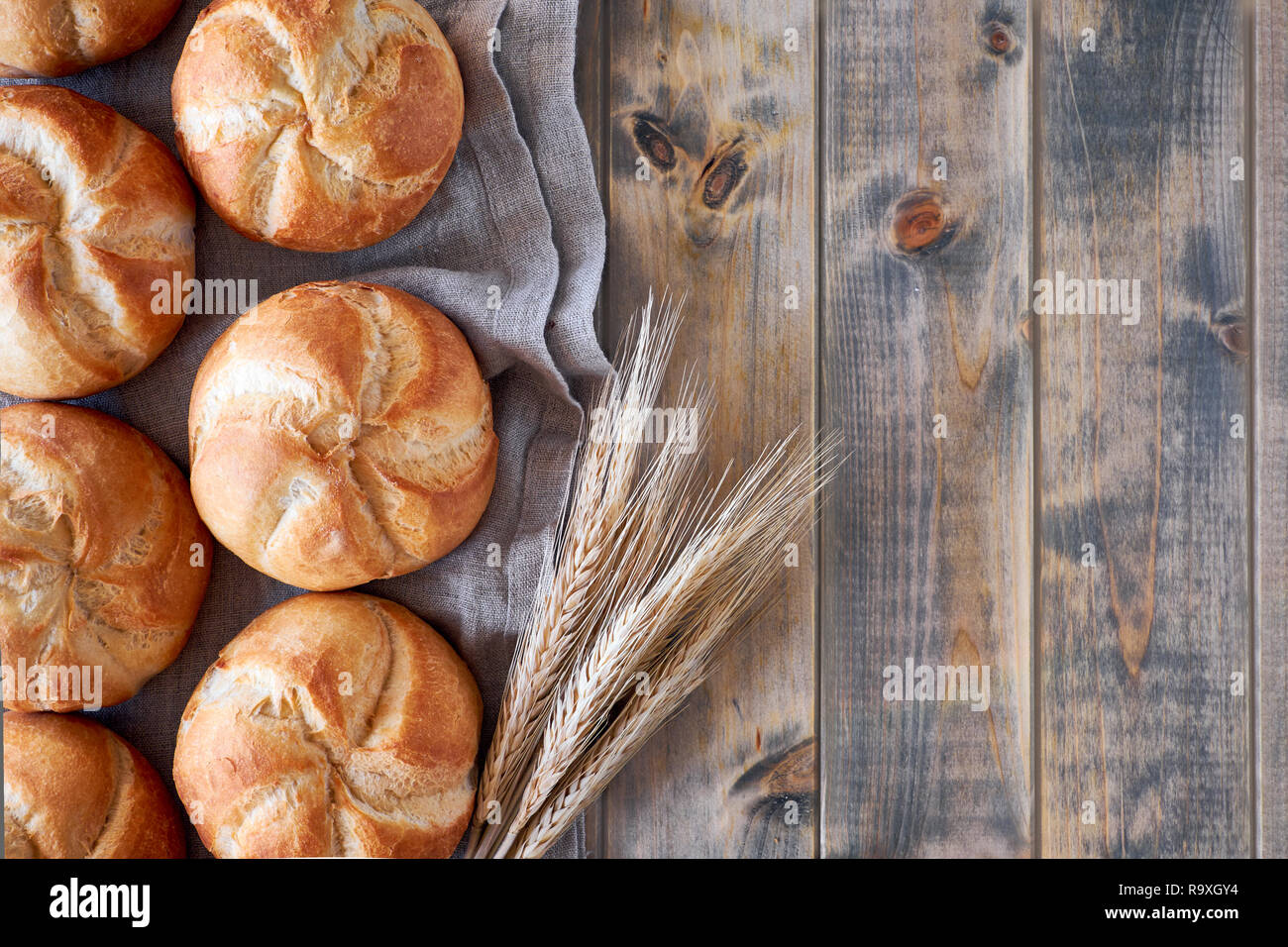 Crusty round bread rolls, known as Kaiser or Vienna rolls scattered on ...