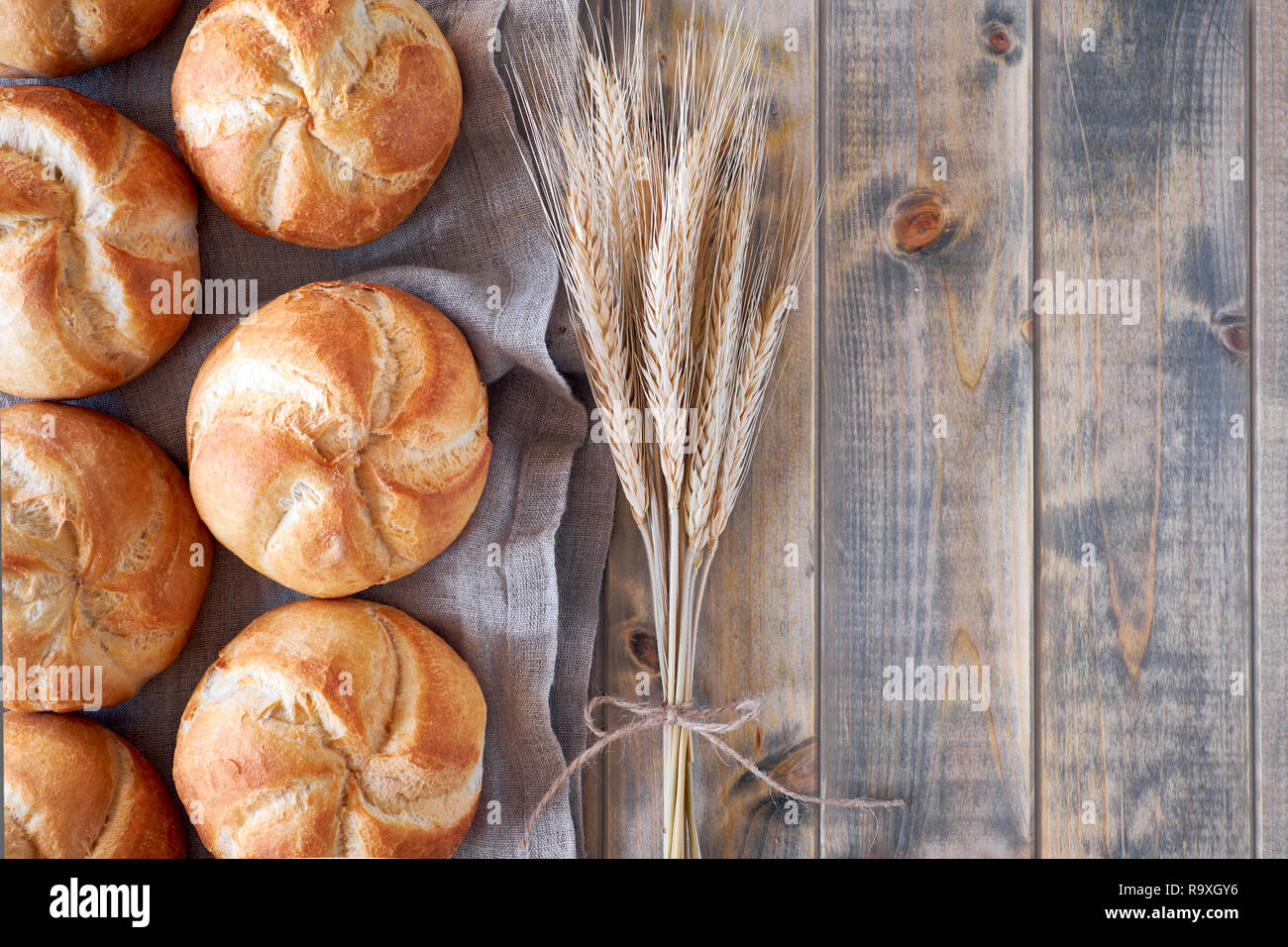 Crusty round bread rolls, known as Kaiser or Vienna rolls scattered on ...