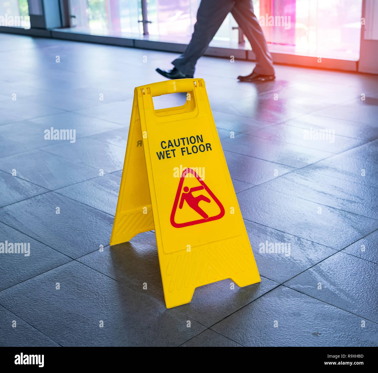 Yellow Caution wet floor sign on wet floor with red bucket Stock Photo ...