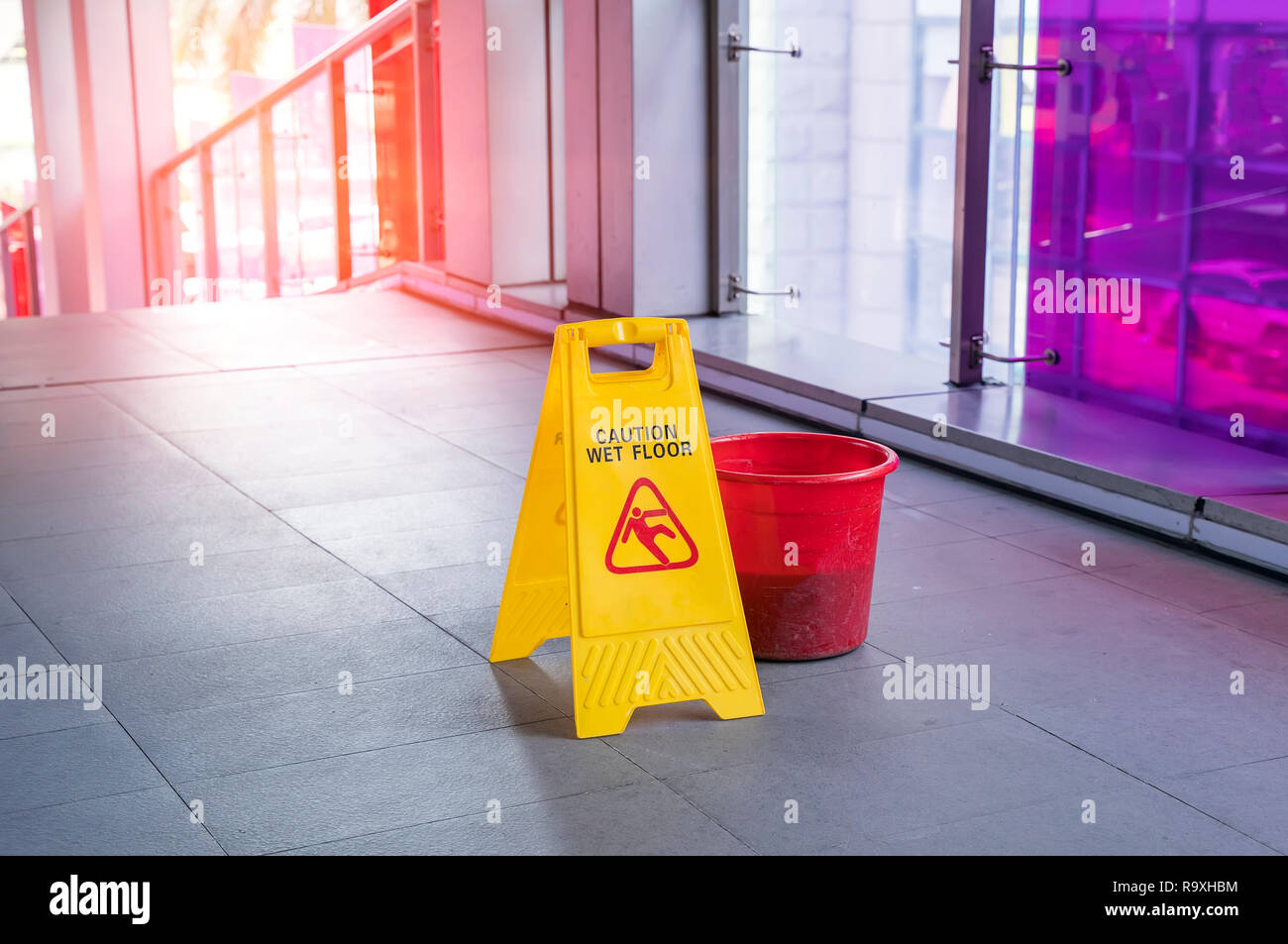 Yellow Caution wet floor sign on wet floor with red bucket Stock Photo ...