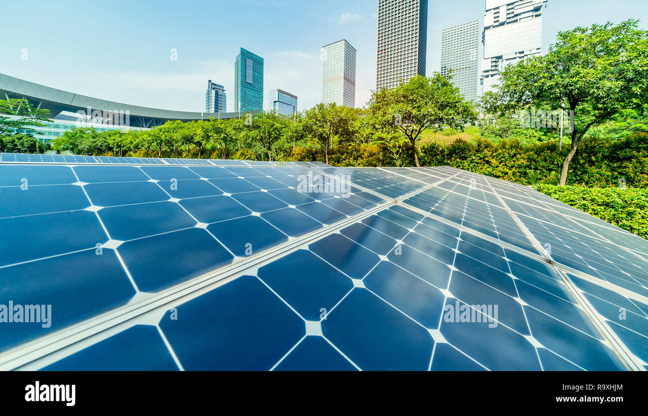 Ecological energy renewable solar panel plant with urban landscape ...