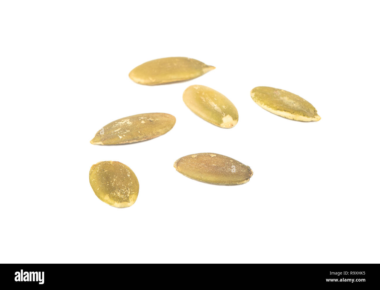 Several pumpkin seeds without the shell on white background Stock Photo ...