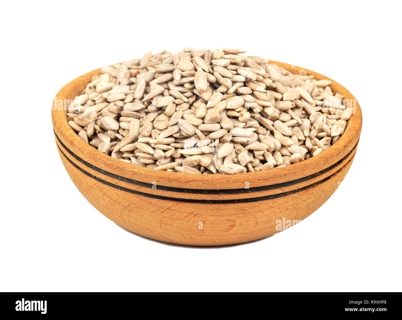 Sunflower seeds without shell in a wooden bowl on a white background ...