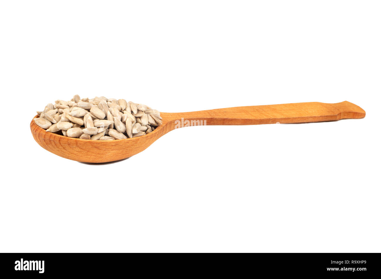 Sunflower seeds without shell in spoon on white background Stock Photo ...